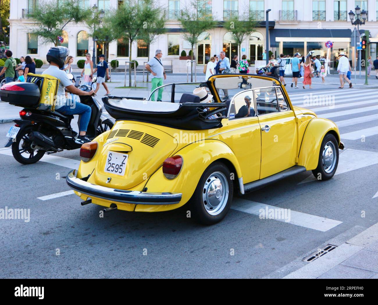 Yellow convertible classic Volkswagen Beetle 1303 car driving through ...