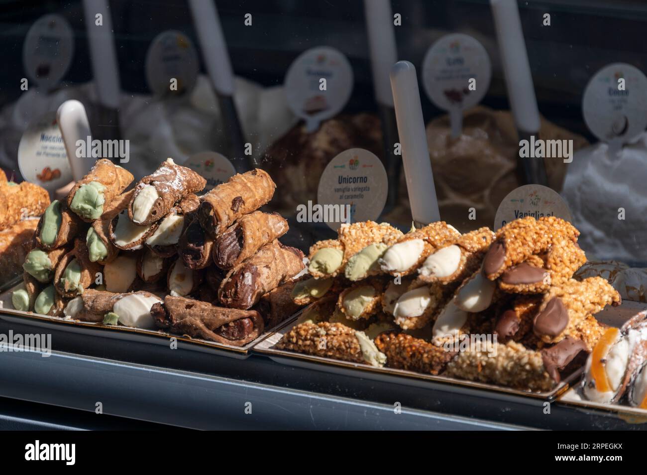 A bakery window of a mixed selection of freshly baked pastries in ...