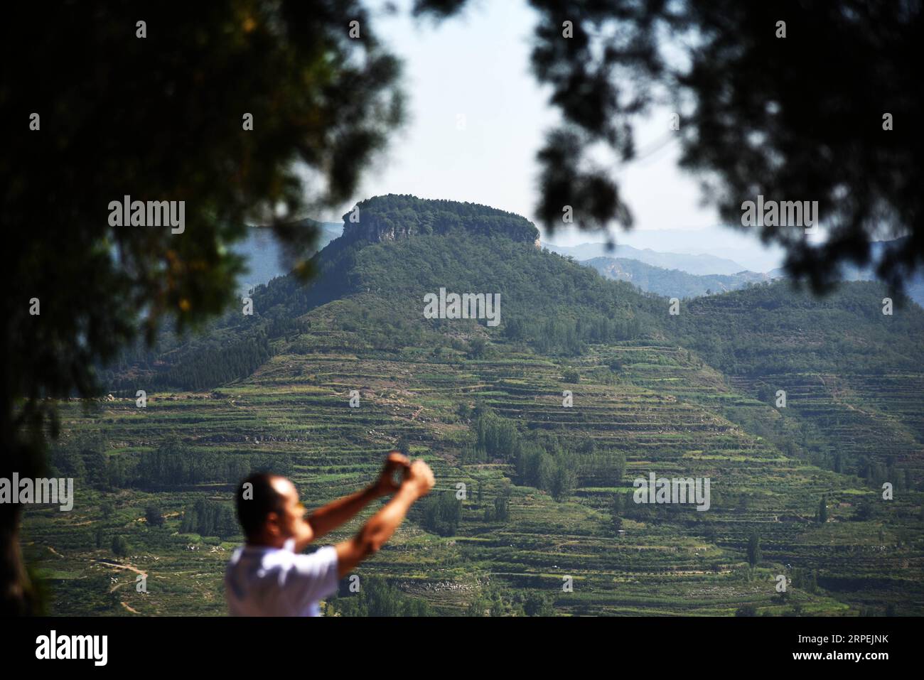 (190830) -- MENGYIN, Aug. 30, 2019 -- A tourist takes photos at Daigu ...