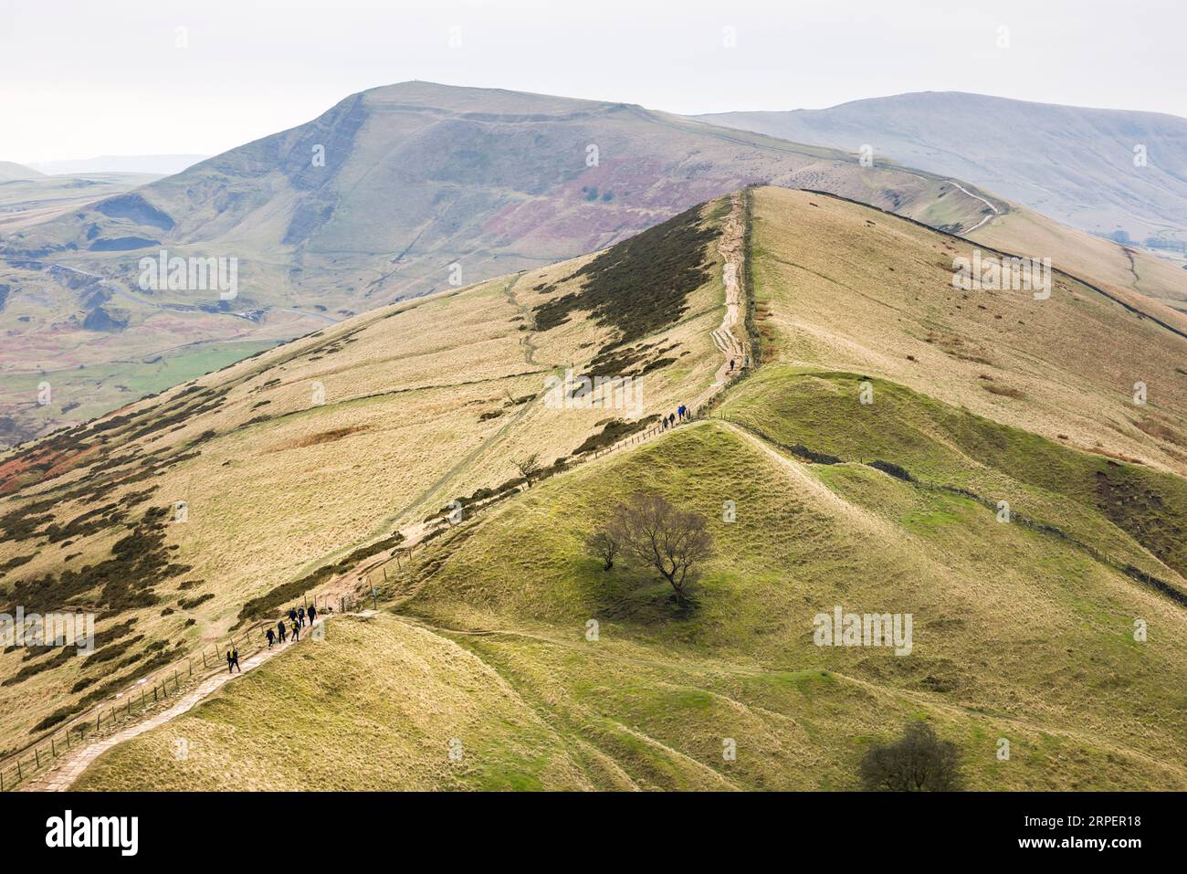 PEAK DISTRICT, UK - March 02, 2023. Hikers on a footpath climbing ...
