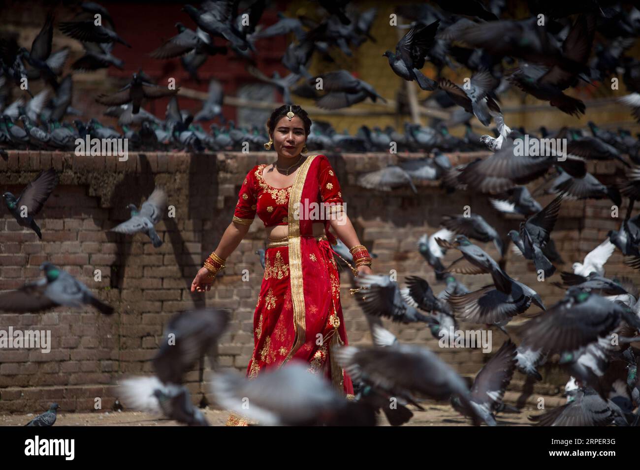 (190903) -- BEIJING, Sept. 3, 2019 -- Pigeons fly around a woman during ...