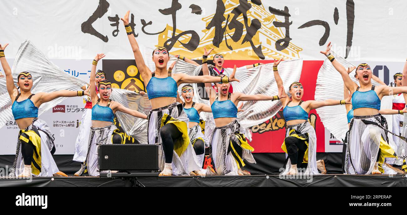 Japanese teenage women Yosakoi dance team in silver and blue costumes ...
