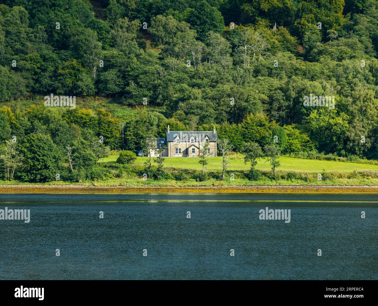View across Loch Fyne to a lakeside country house, Argyll, Scotland, UK ...