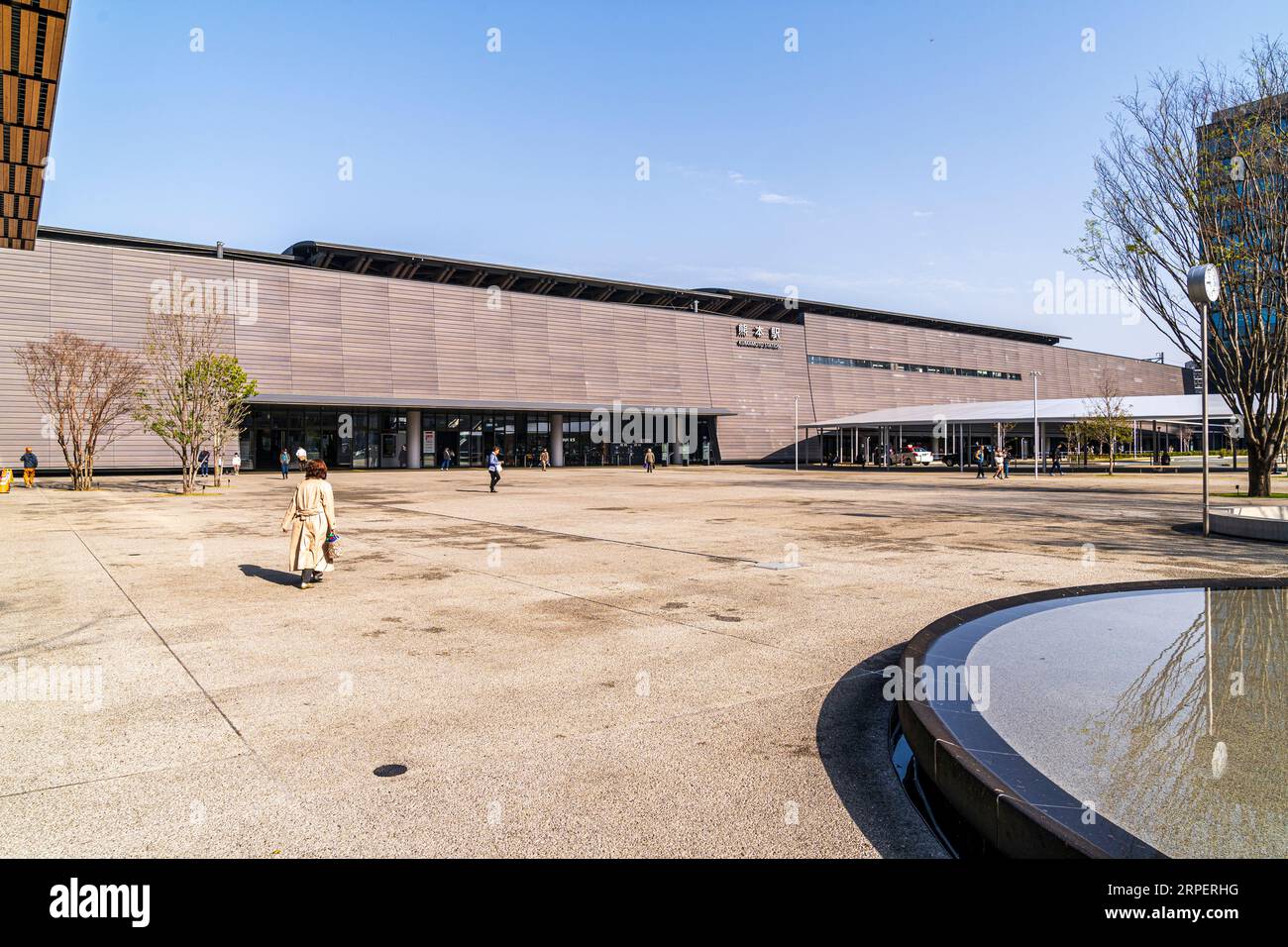 Kumamoto JR station building in bright sunshine with clear blue sky ...