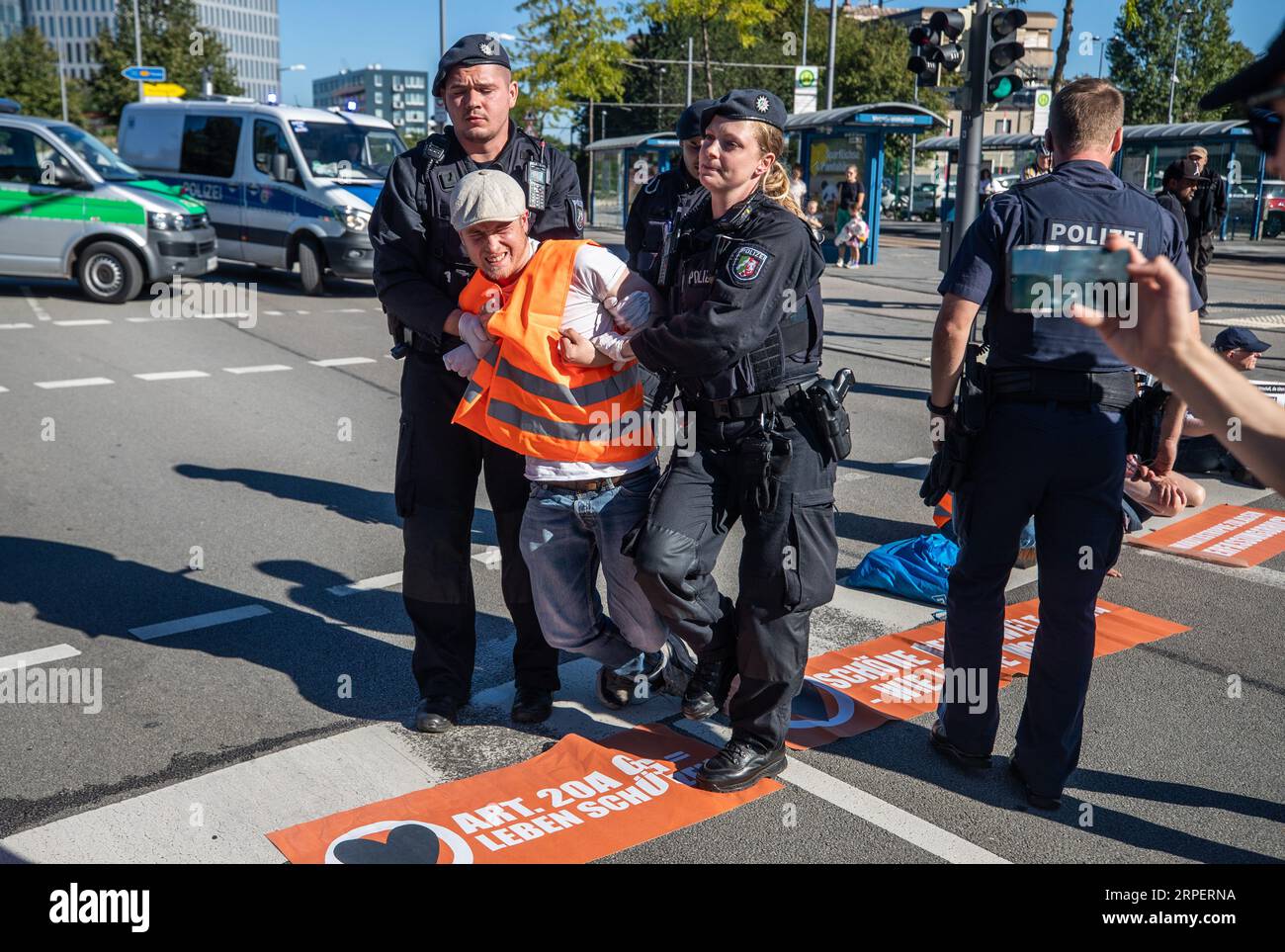 Munich, Germany. 04th Sep, 2023. Police units remove a climate activist ...