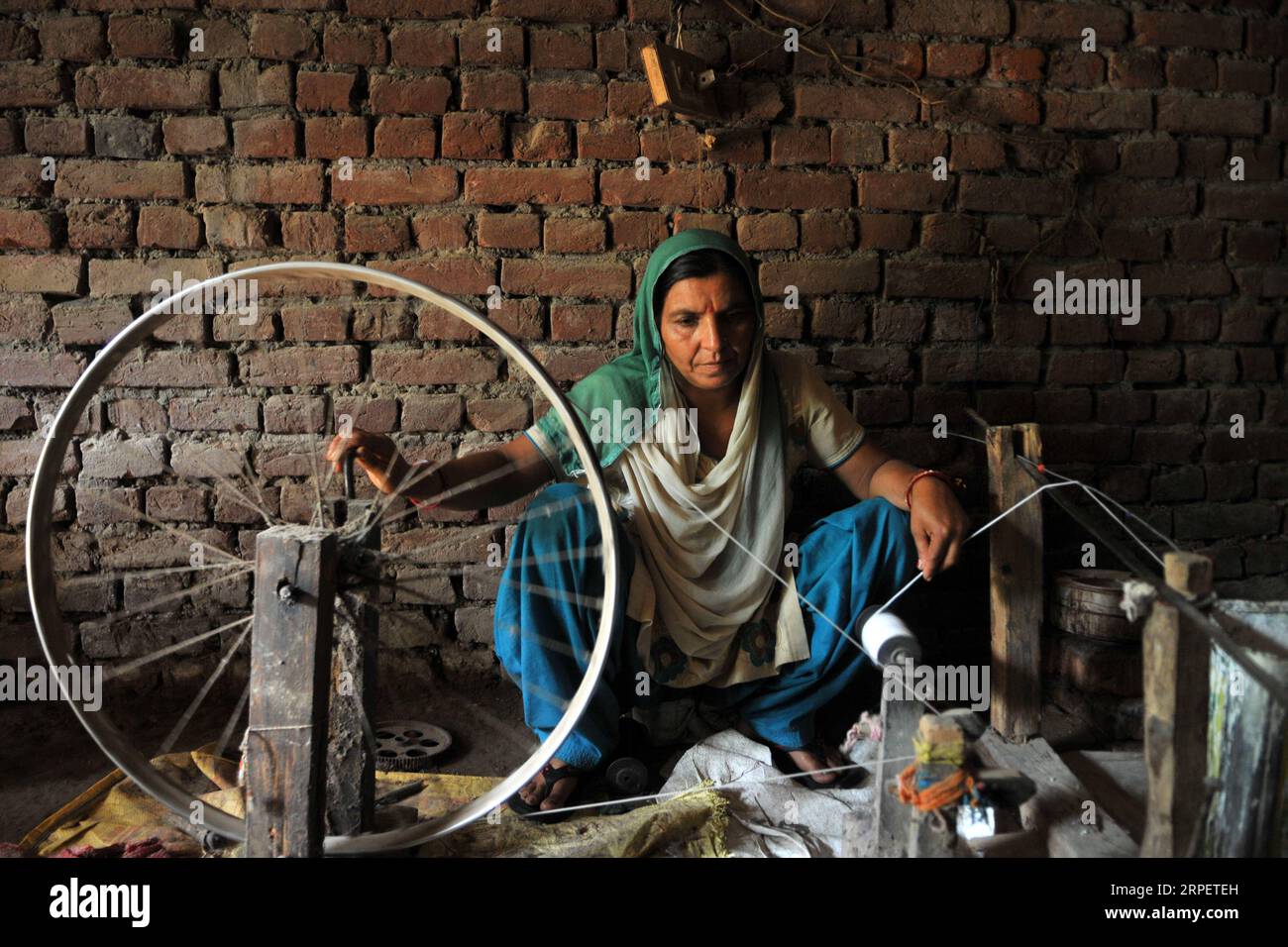 (190904) -- JAMMU, Sept. 4, 2019 -- A weaver handles a spinning wheel ...