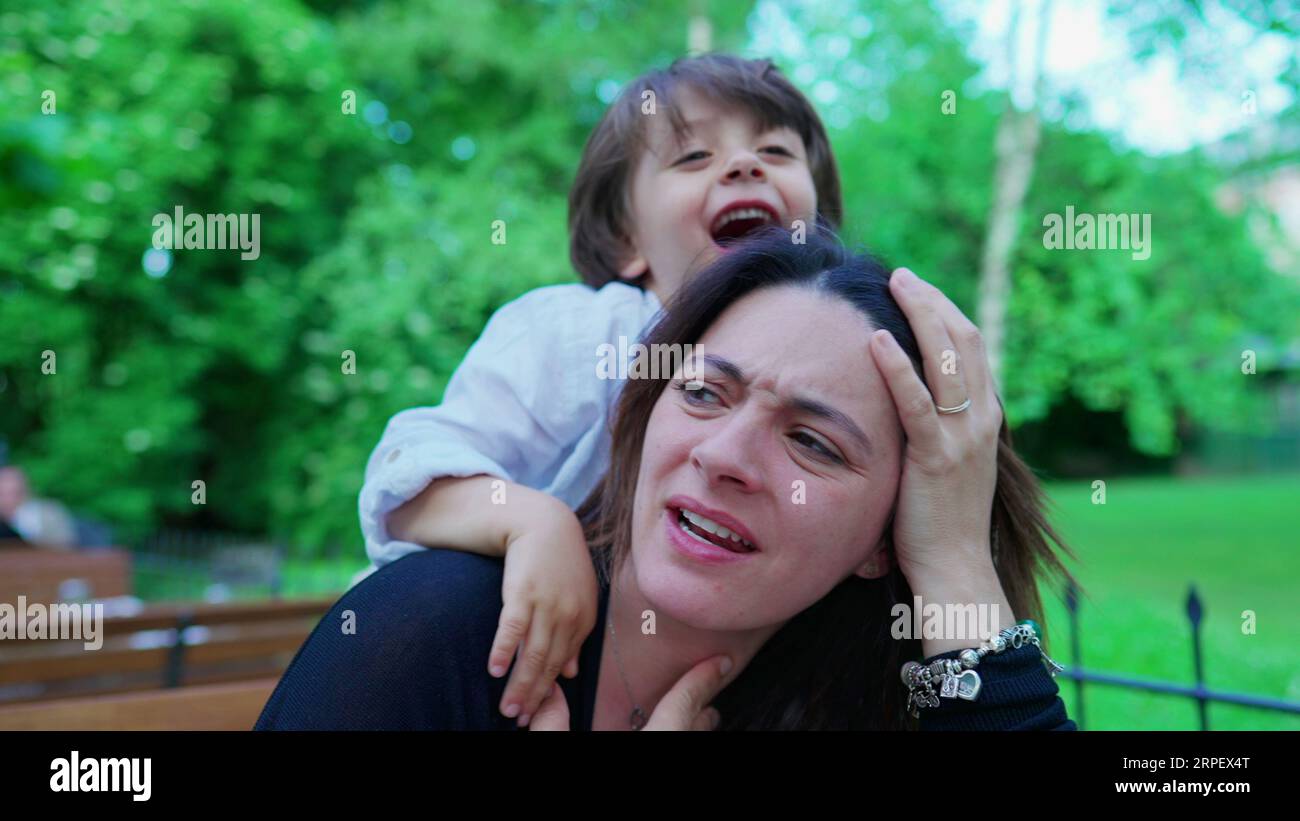 Careless small boy choking mom while playing. Kid not knowing play ...