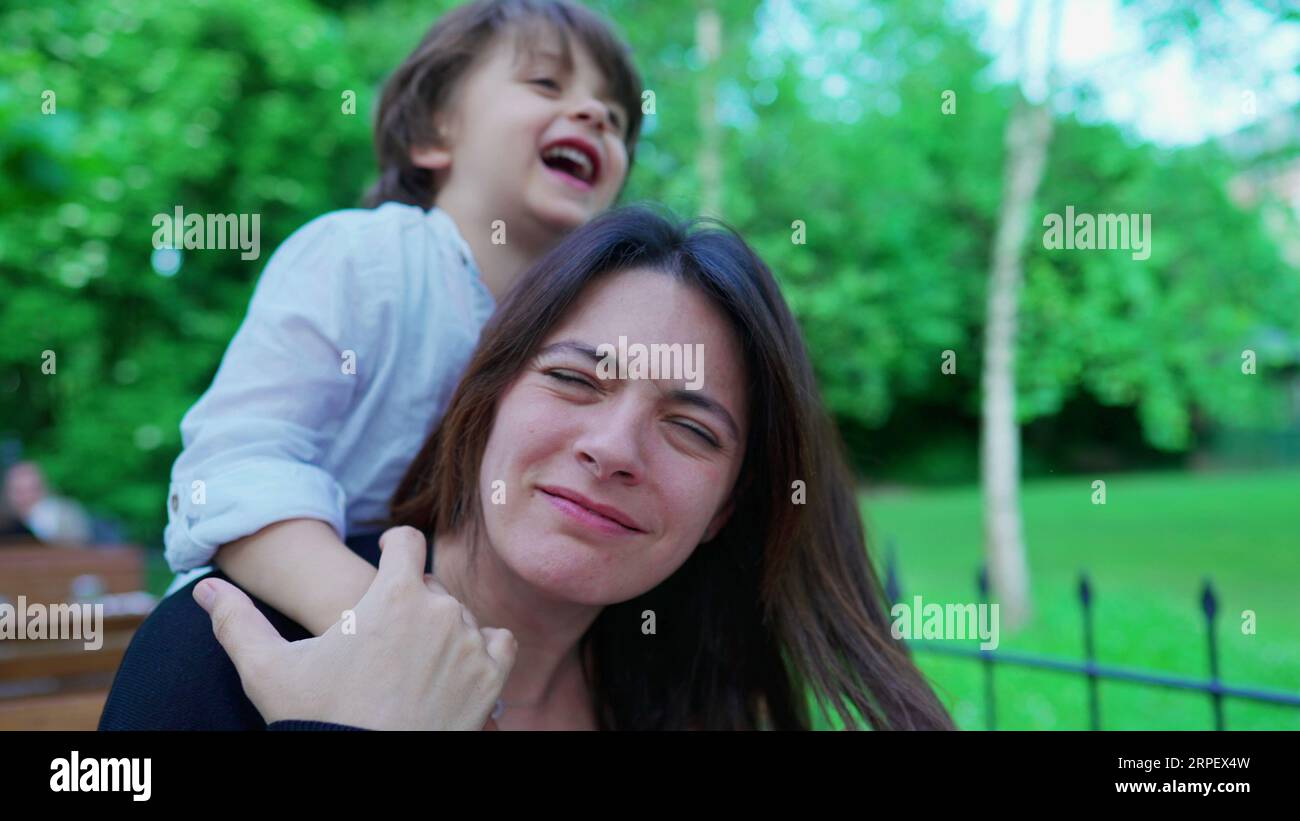 Careless small boy choking mom while playing. Kid not knowing play ...