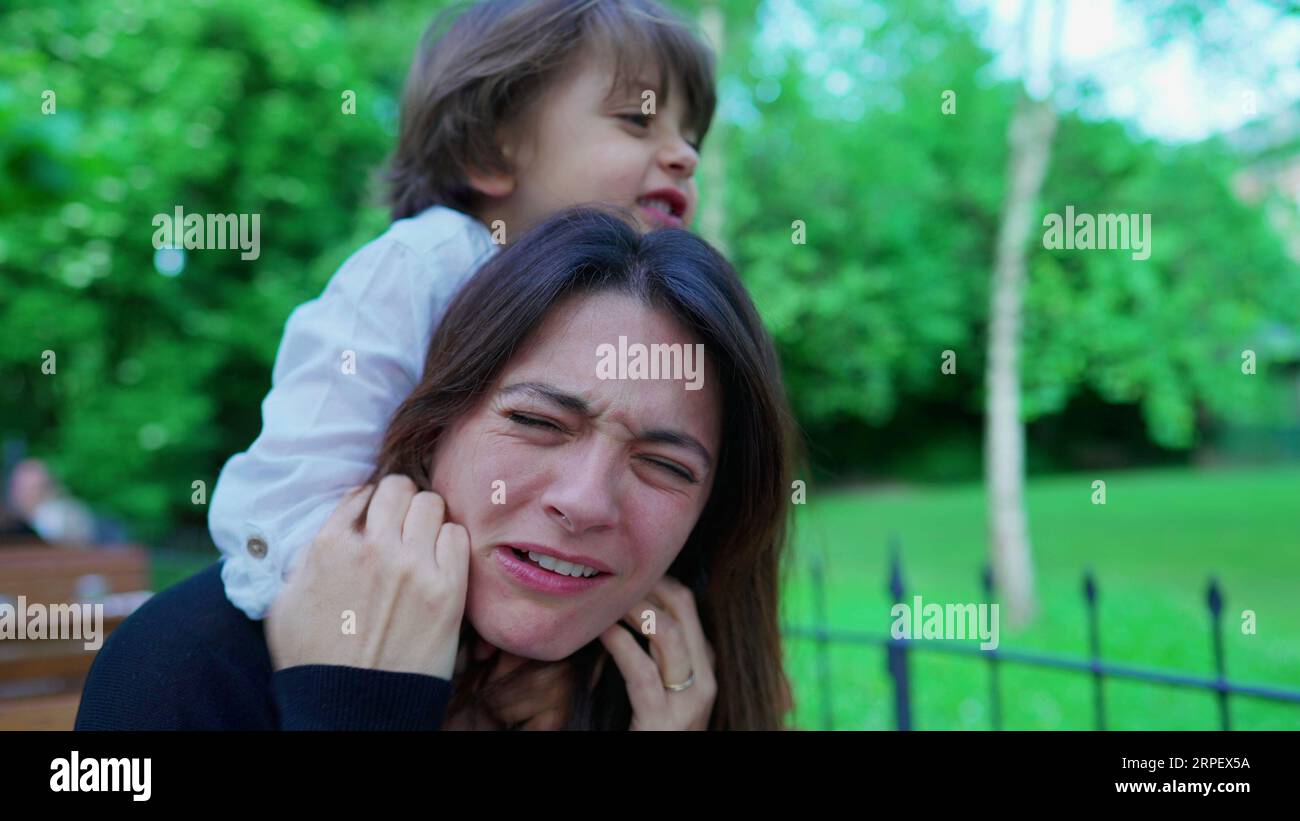 Careless small boy choking mom while playing. Kid not knowing play ...