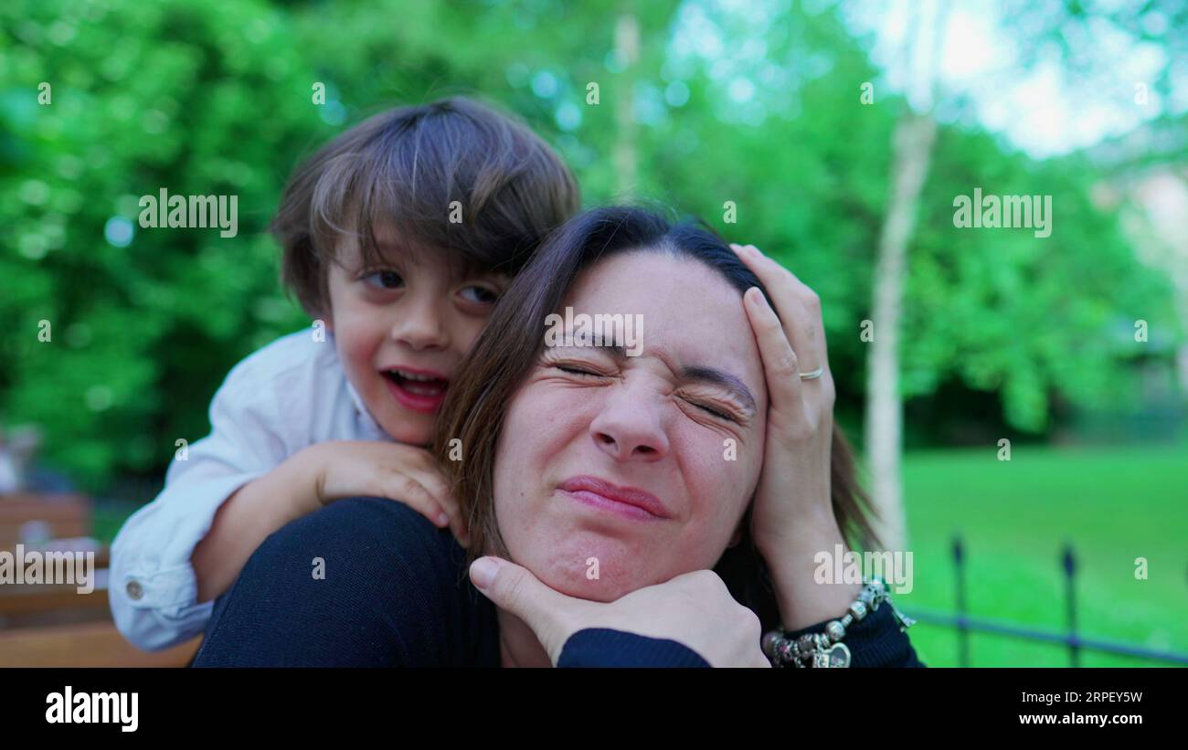 Careless small boy choking mom while playing. Kid not knowing play ...