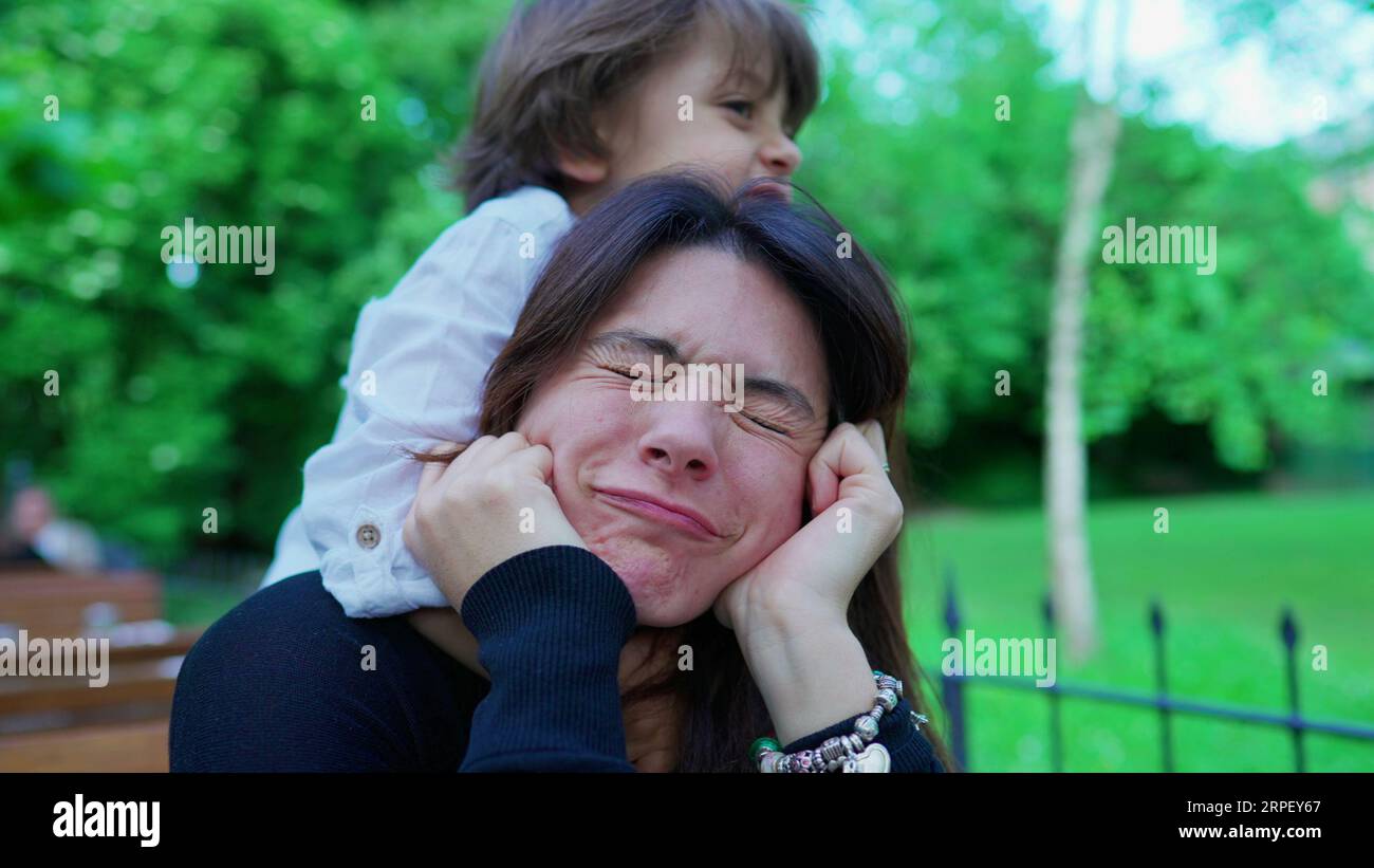 Careless small boy choking mom while playing. Kid not knowing play ...