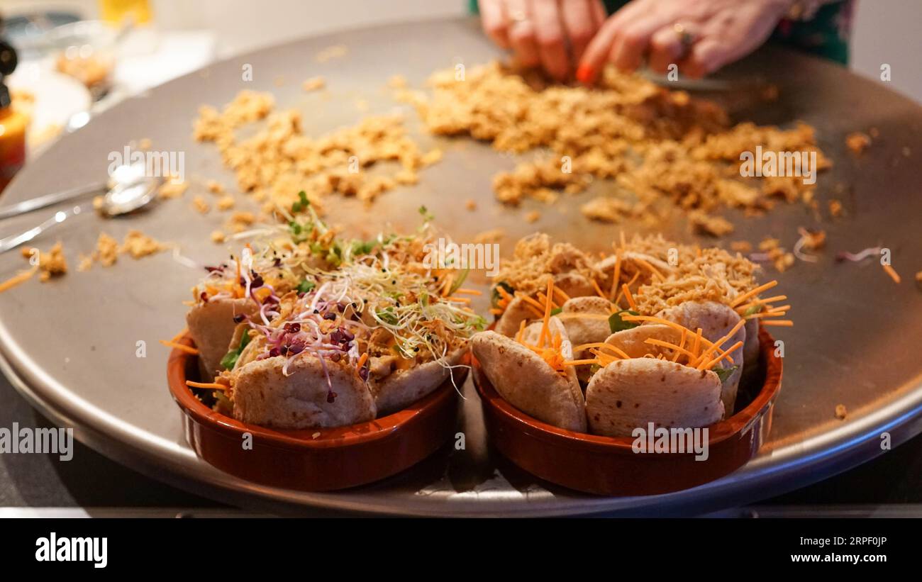 A white plate displaying three small dishes of food Stock Photo - Alamy