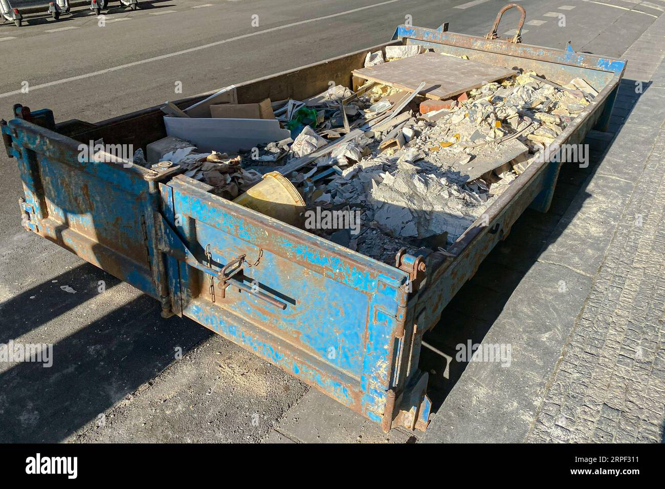 metal dumpster waste container filled with construction waste, rubble ...