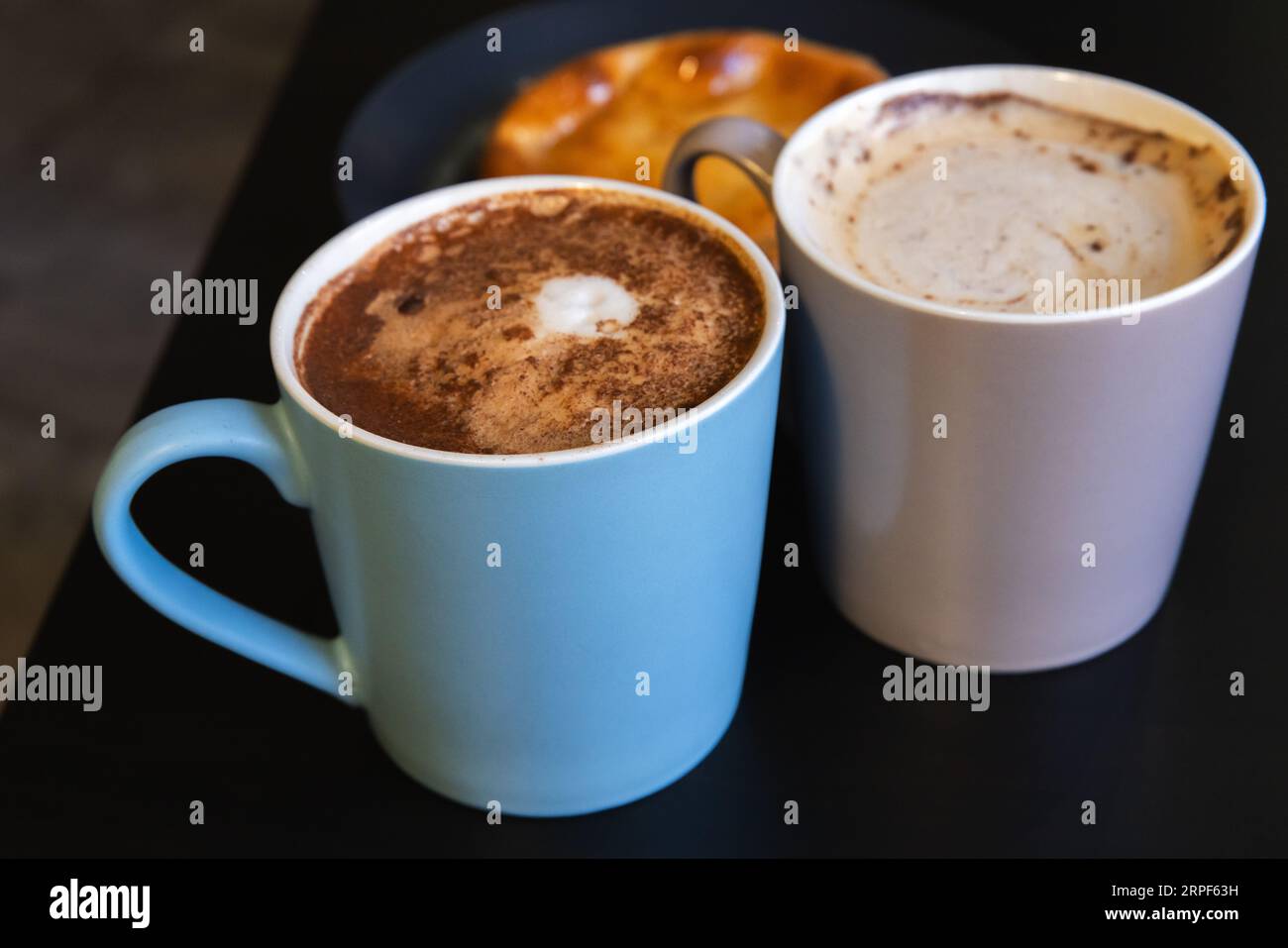 Two Cappuccino cups. Mugs full of coffee with milk foam and cinnamon ...