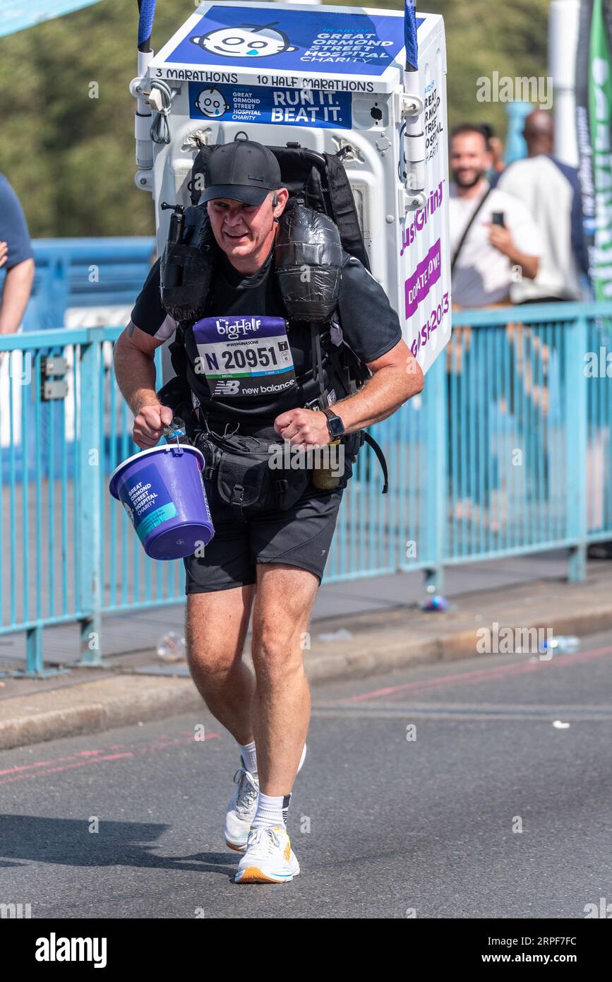 Jason Bird competing in The Big Half, half marathon, crossing Tower ...