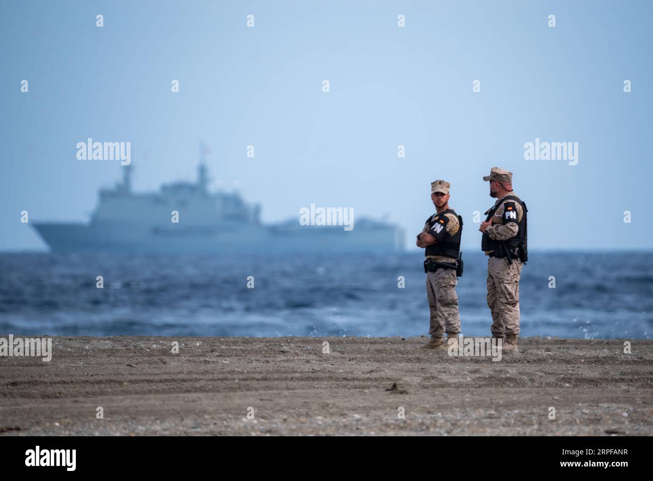 Naval police of the Spanish Navy in front of a ship on surveillance ...