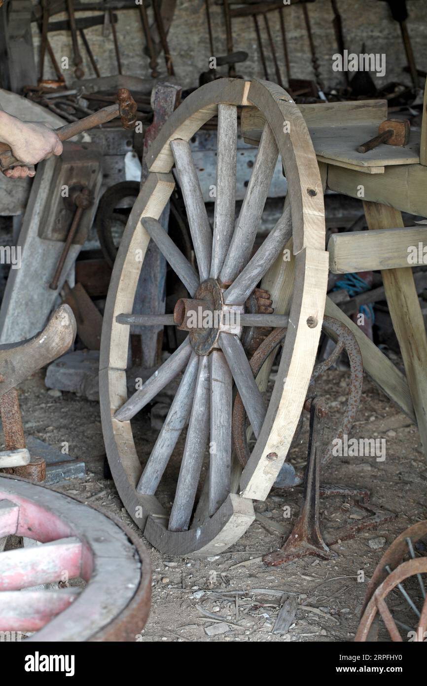 Wheelwirght's wooden wheel for a cart in a wheelwrights workshop Stock ...