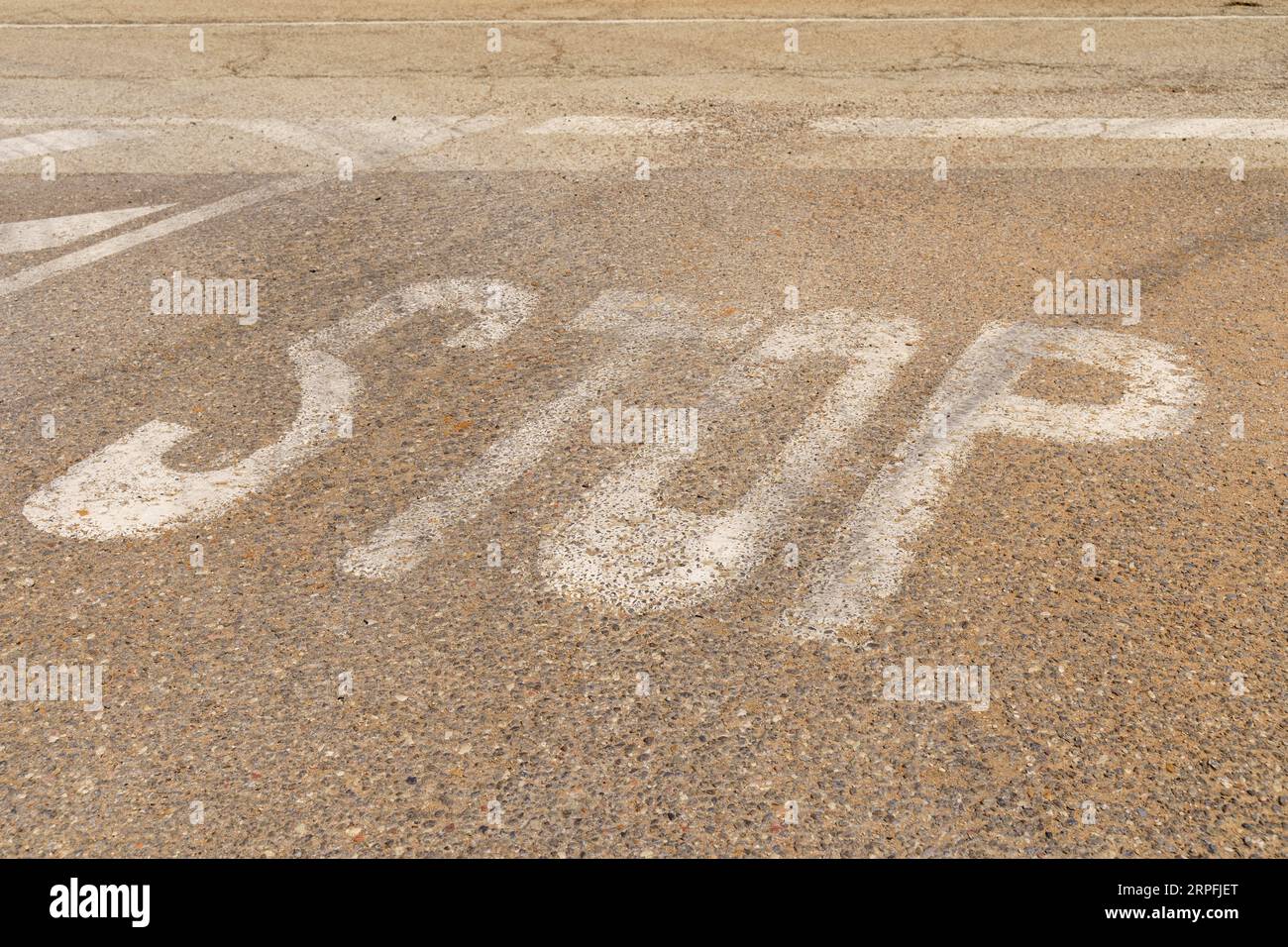 Road markings are drawn on the asphalt - a stop line and the ...