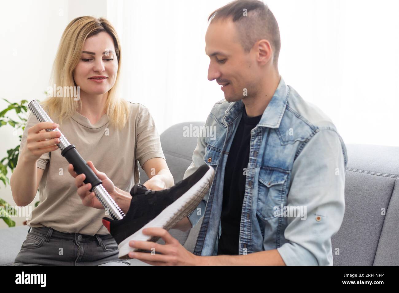 Female technician assembling and fixing parts of modern prosthetic leg ...