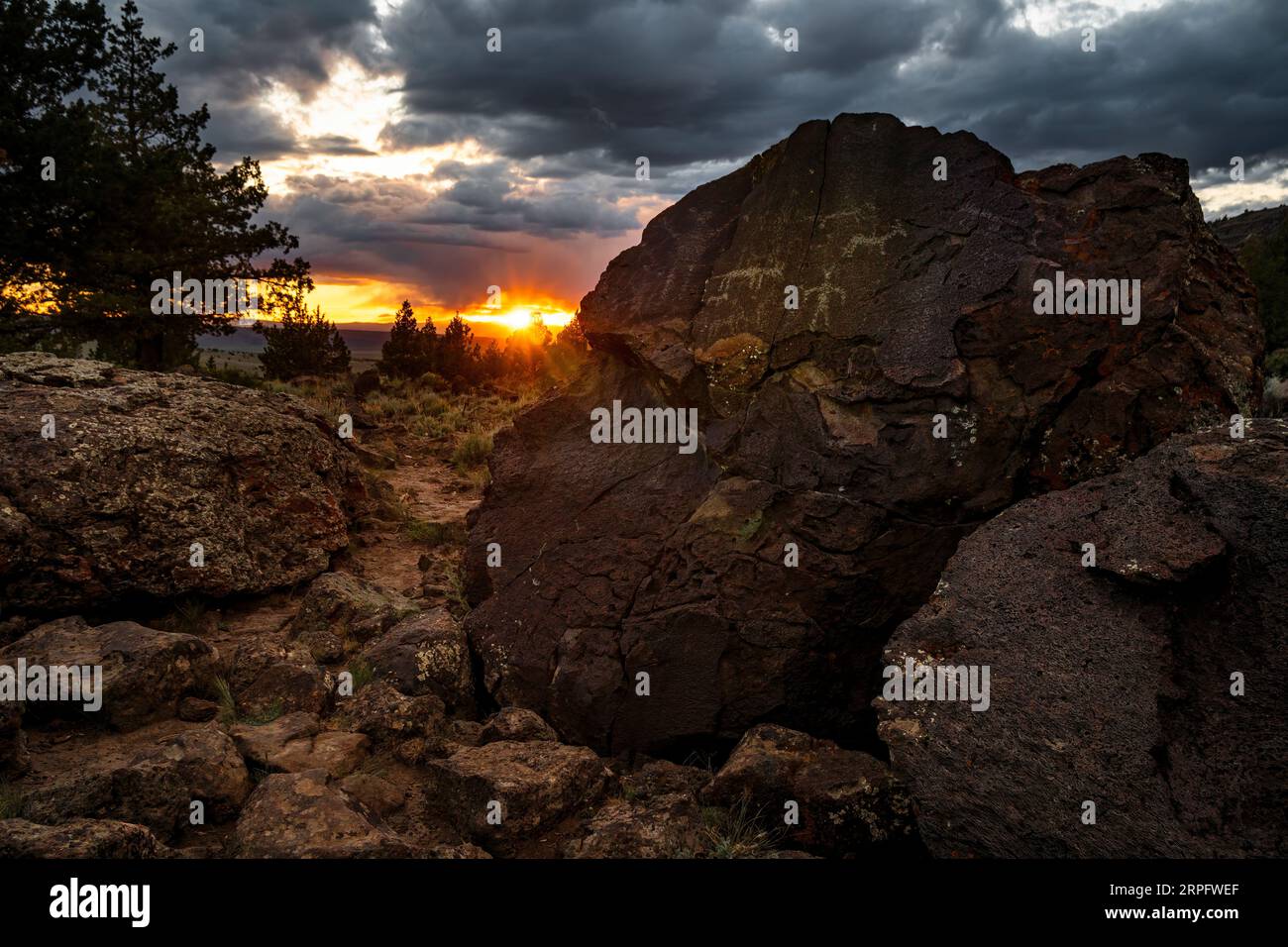 The setting sun breaks through the clouds at Picture Rock Pass near ...