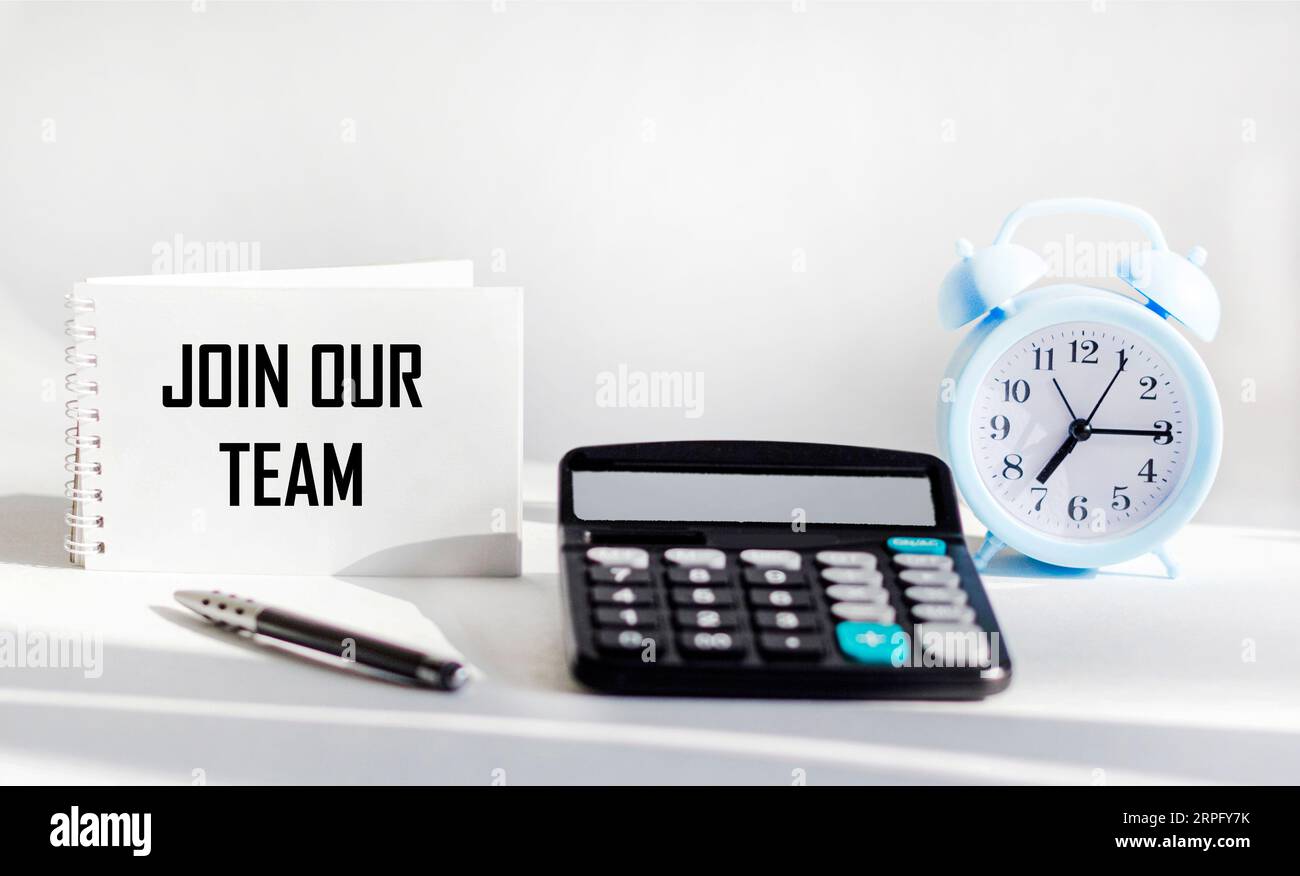Join our team text on notepad and white background with calculator and ...
