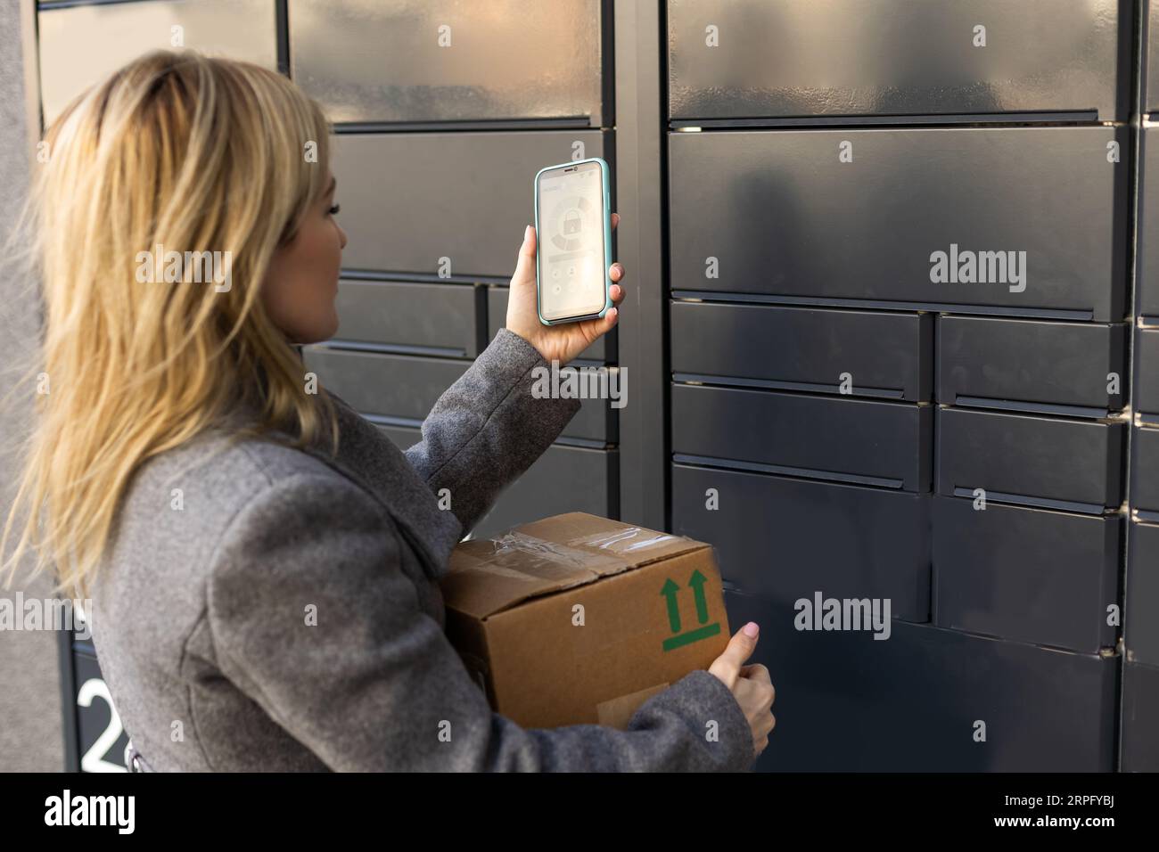 Young woman opening door for delivery service Stock Photo - Alamy