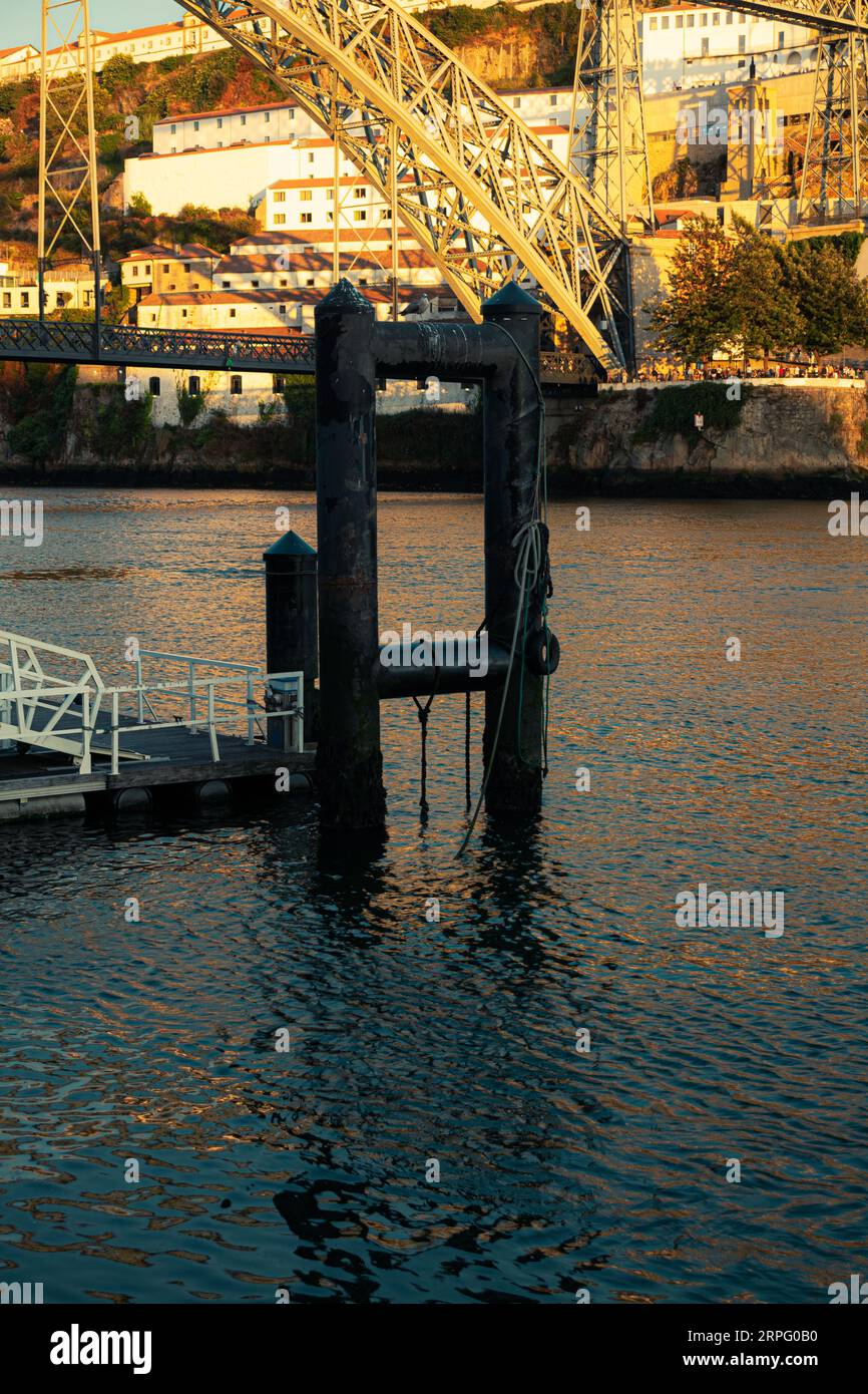 Boat docking station in the middle of the river with an iron bridge D ...