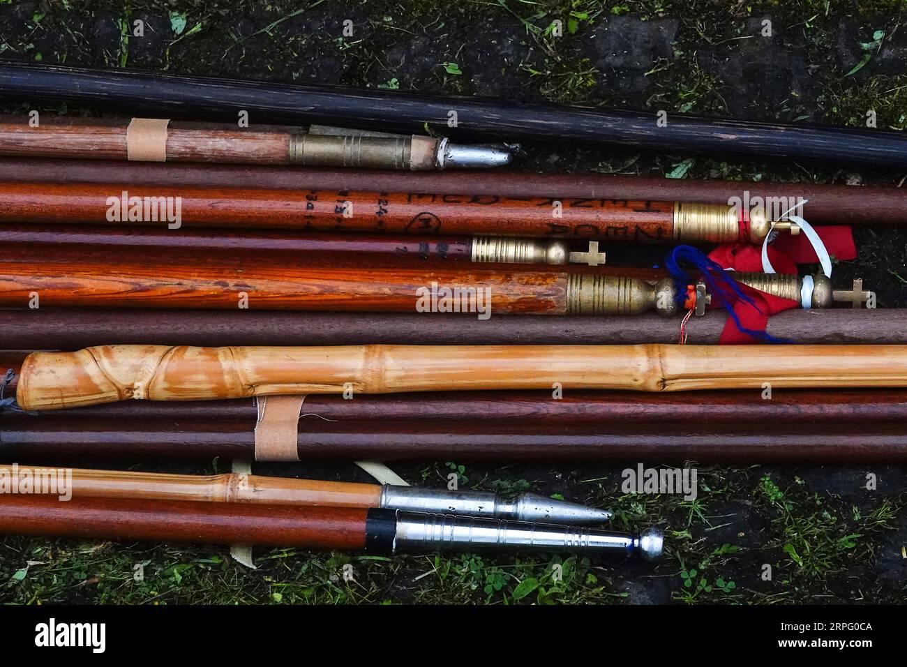 Holy walking sticks of Roman Catholic pilgrims called a Romeiros, piled ...