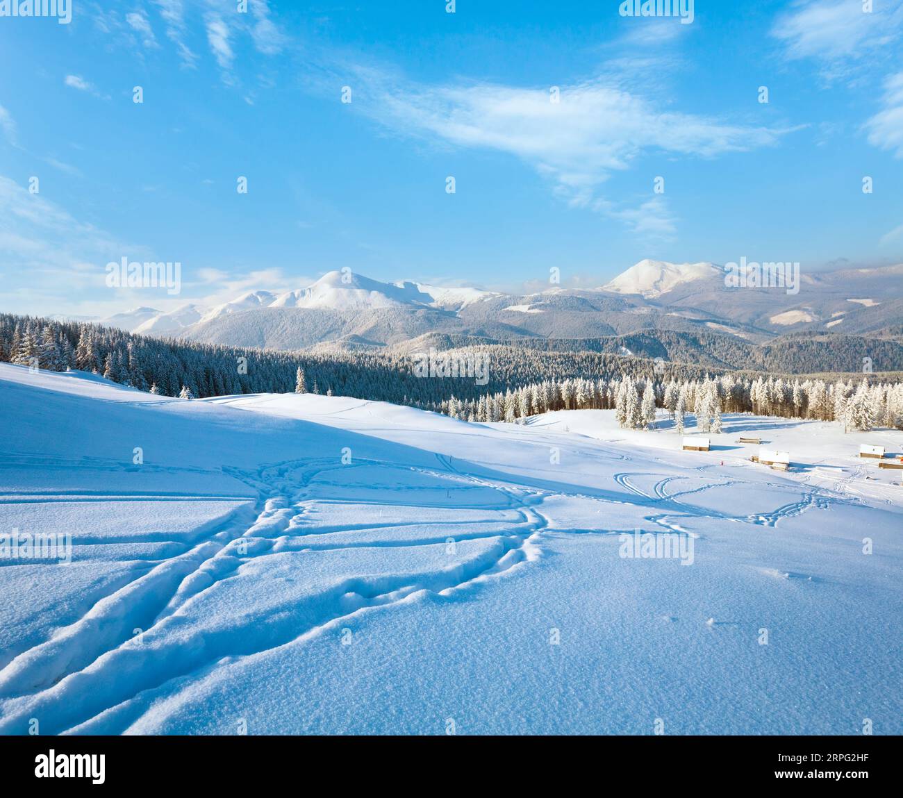 Winter calm mountain landscape with sheds group and mount ridge behind ...