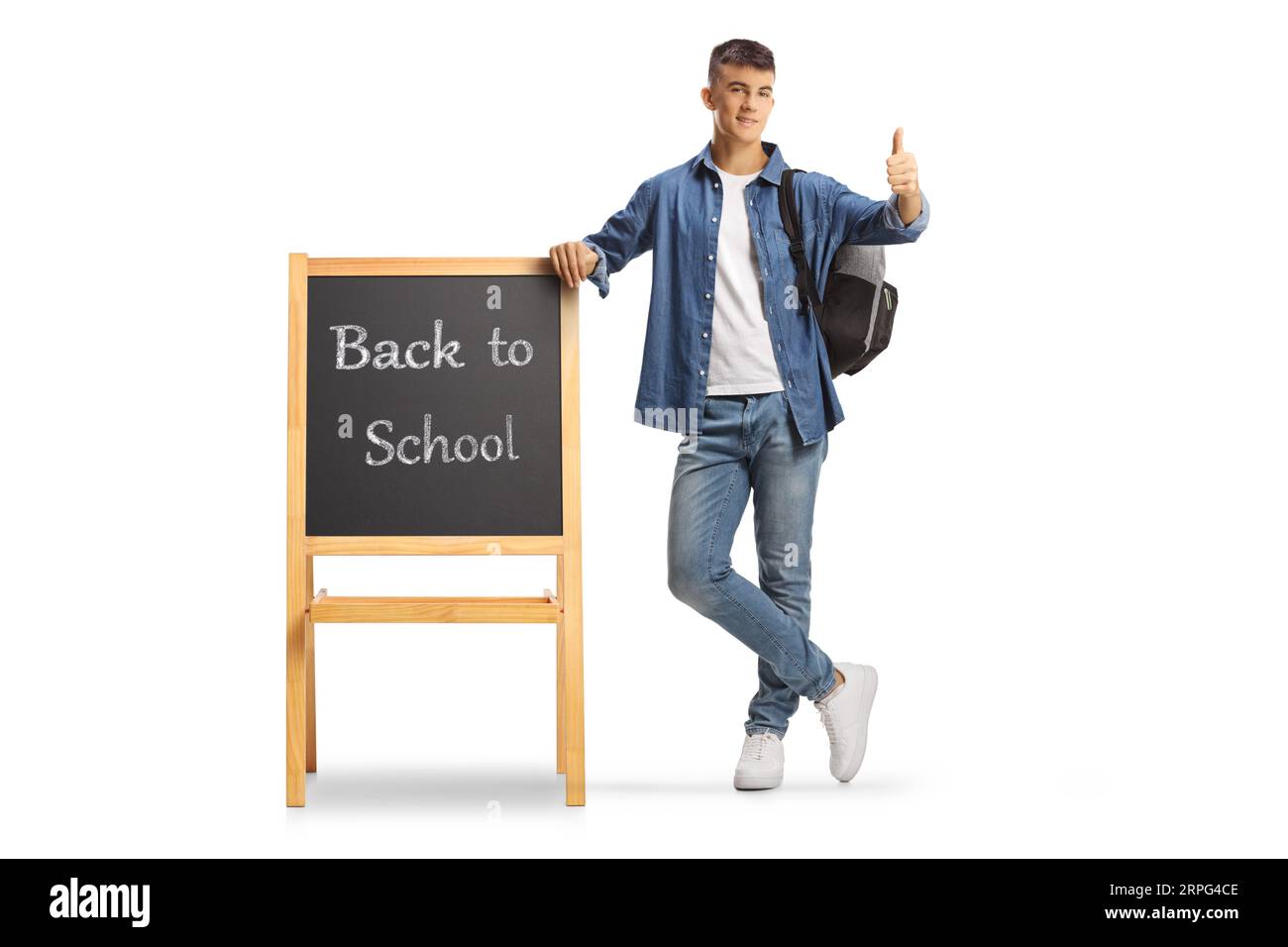Full length portrait of a male teenage student with a backpack leaning ...