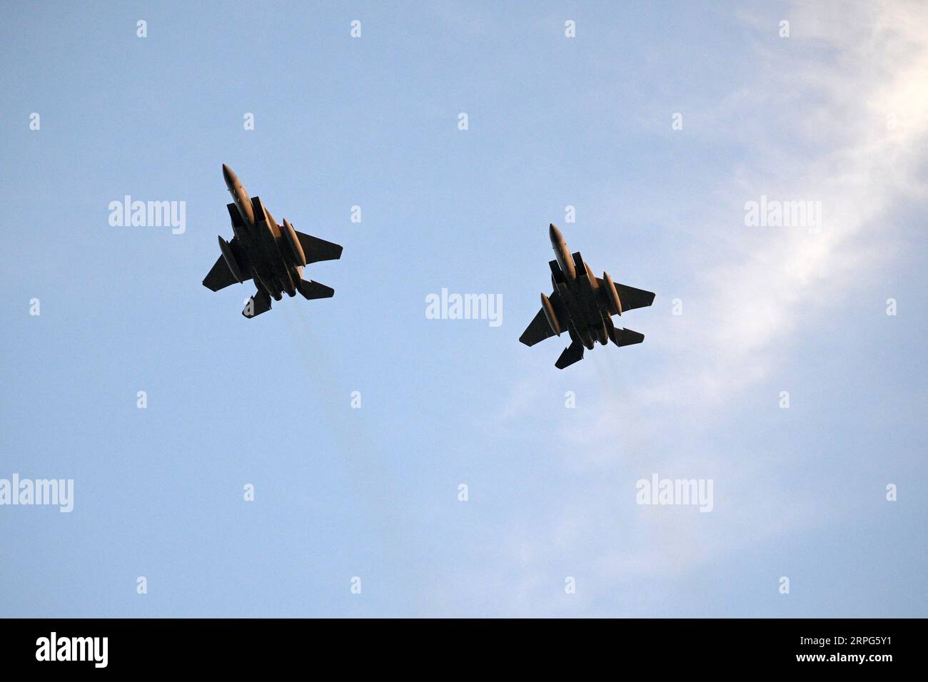 A pair of F-15 military fighter jets perform a flyover during the ...