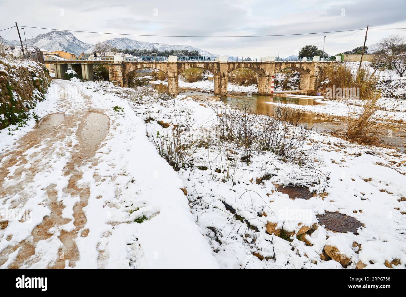 Snowy view of bridge over Gorgos river near Xaló with Serra del ...