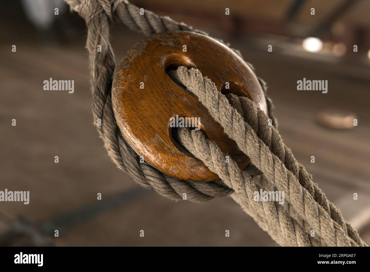 detail of the rigging of an old sailing ship, a wooden triple deadeye ...
