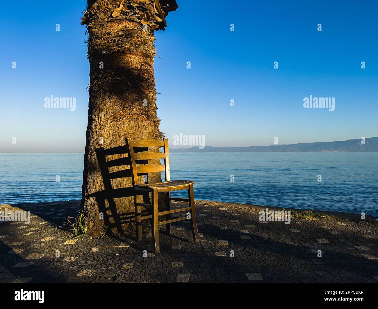 wooden chair by the beach , blue sea and loneliness concept in ...