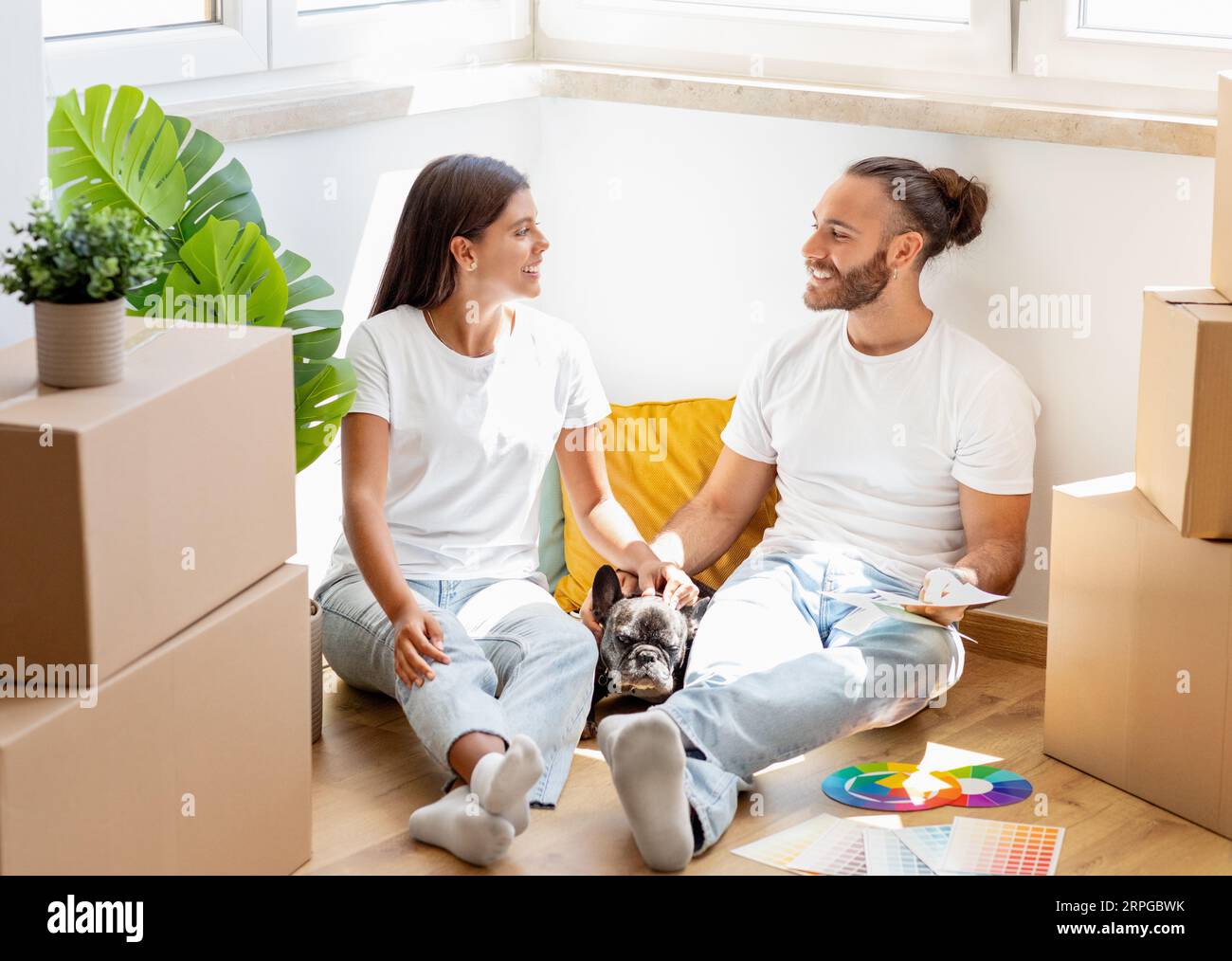 Happy young couple discussing interior design for new house Stock Photo ...