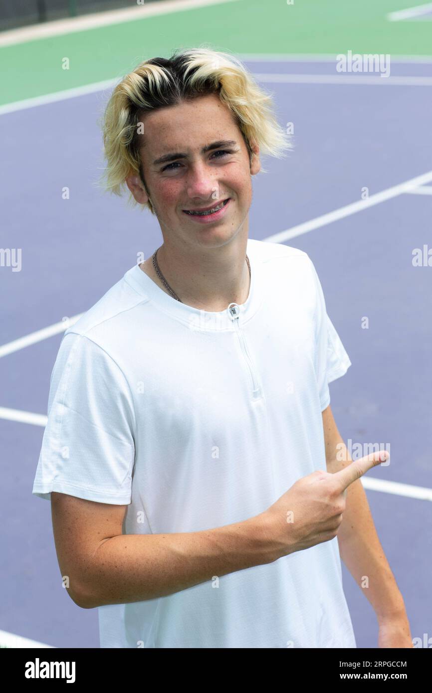 Tennis player giving the number one sign whilst posing for a picture ...