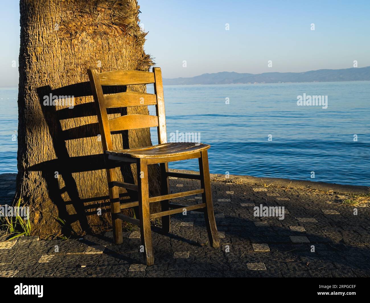 wooden chair by the beach , blue sea and loneliness concept in ...
