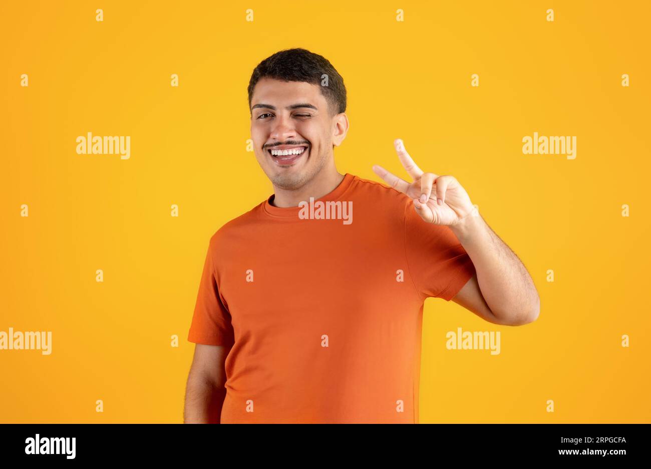 Man winking making peace sign hi-res stock photography and images - Alamy