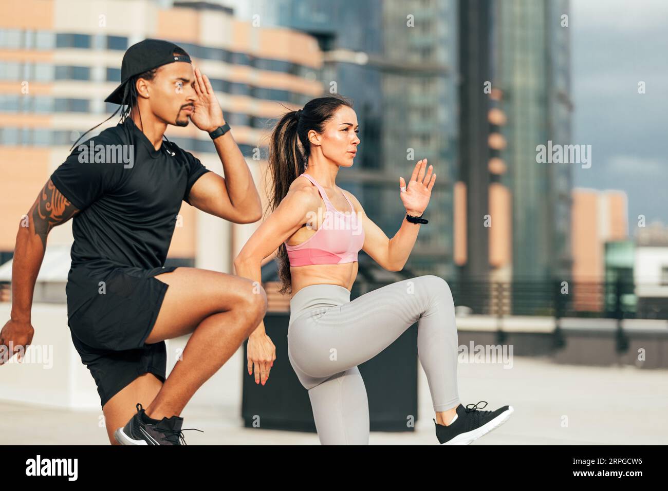 Muscular athletes jumping and running on the rooftop Stock Photo - Alamy