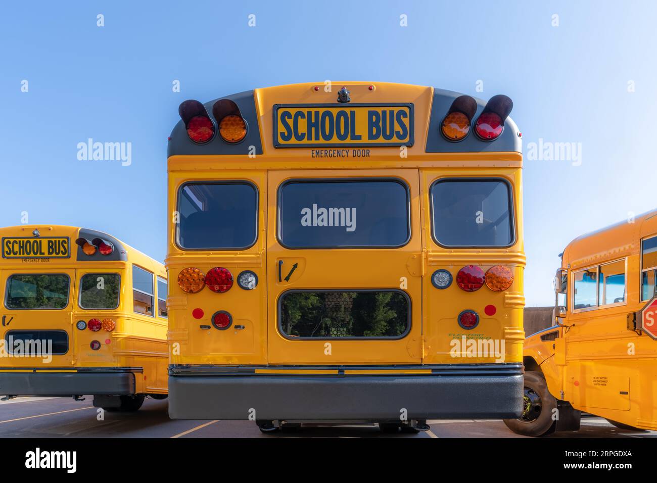 Rear of a parked yellow electric school bus at a charging station Stock ...