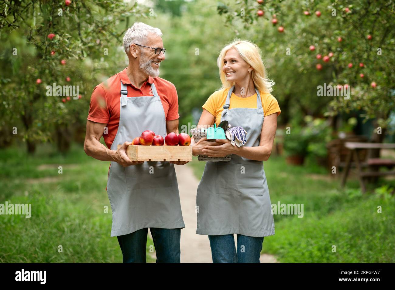 Farming Concept. Happy Mature Farmer Spouses Walking In Fruit Orchard ...