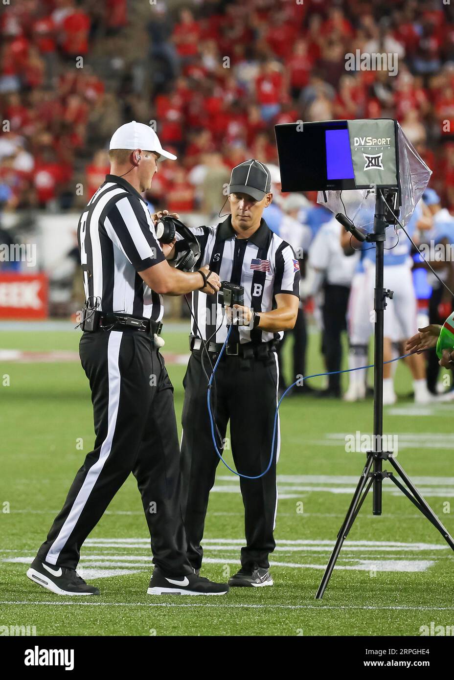 HOUSTON, TX- SEPTEMBER 02: Referee Luke Richmond accepts a headset from ...