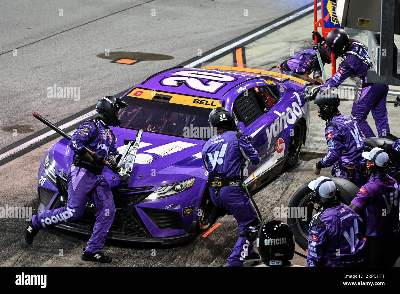 The pit crew for Christopher Bell (20) rushes to complete a pit stop ...