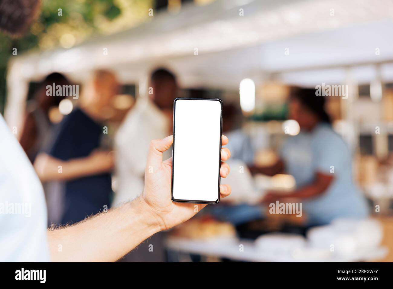 Photo focus on caucasian hand vertically grasping mobile device showing ...