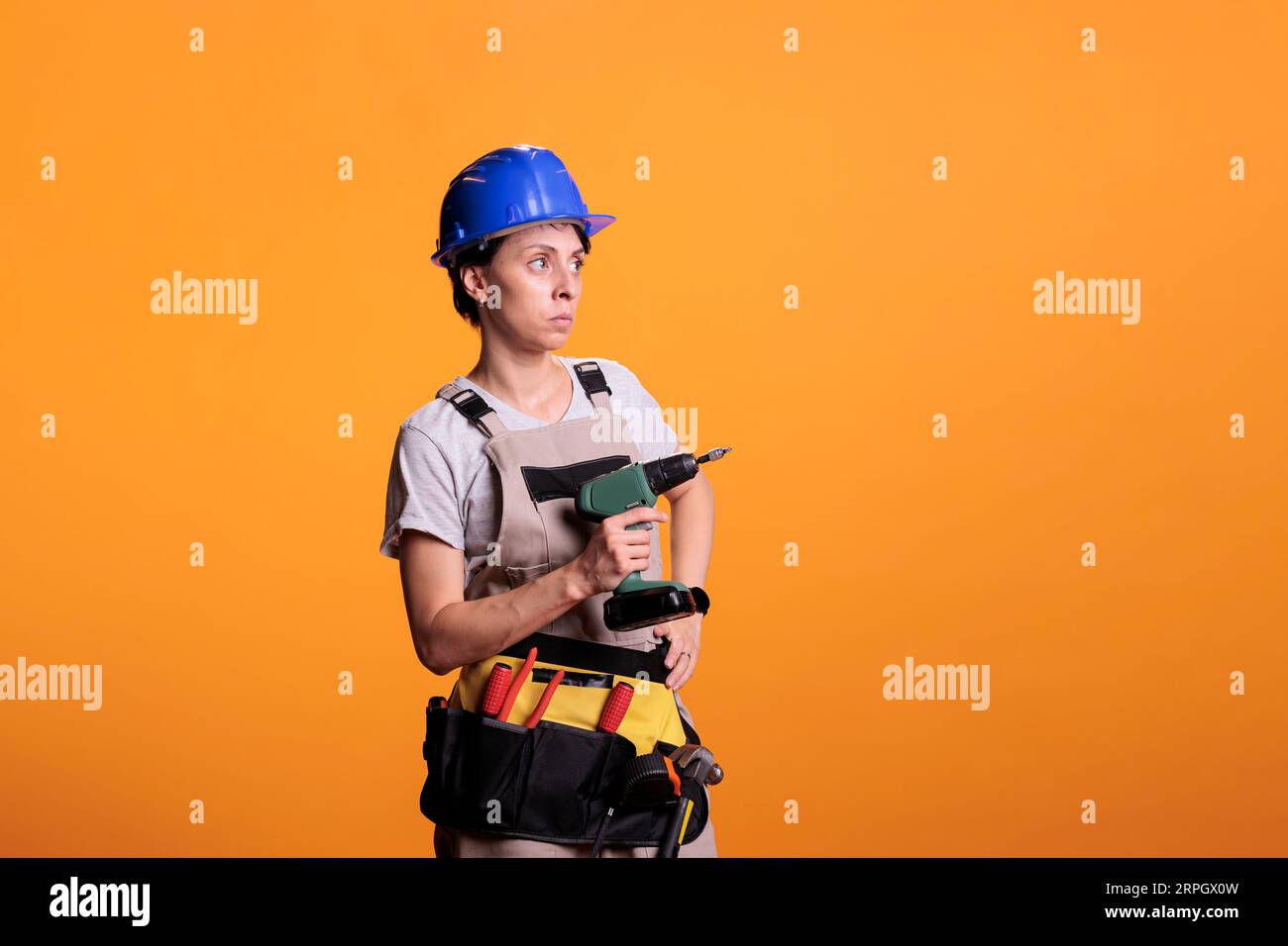 Female construction worker in work uniform with protective helmet ...