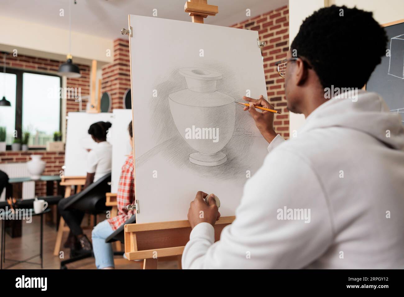 Young people friends attending drawing class, learning new skills ...