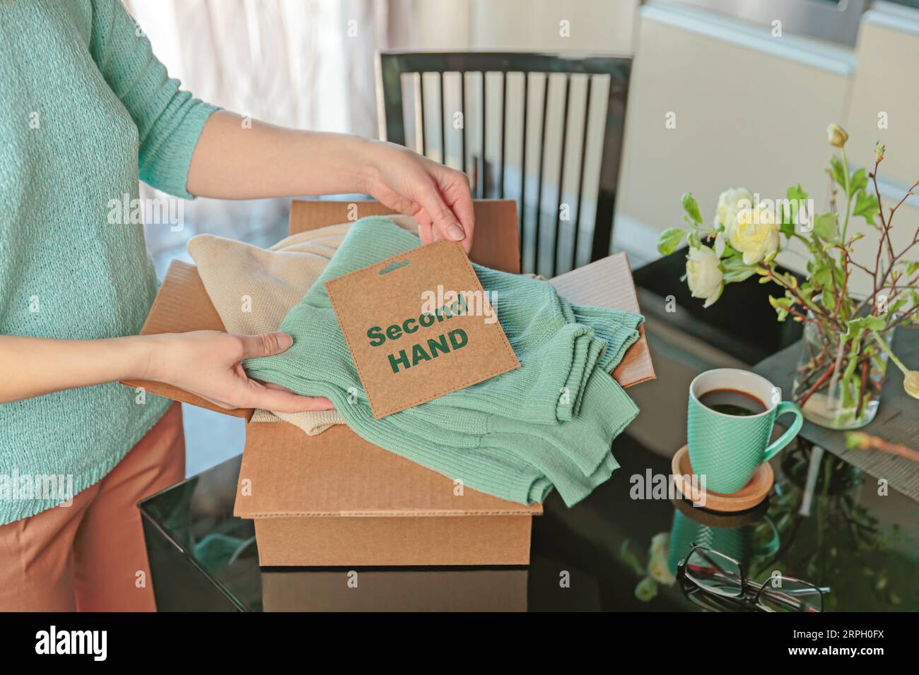 Woman packing used clothes box hi-res stock photography and images - Alamy