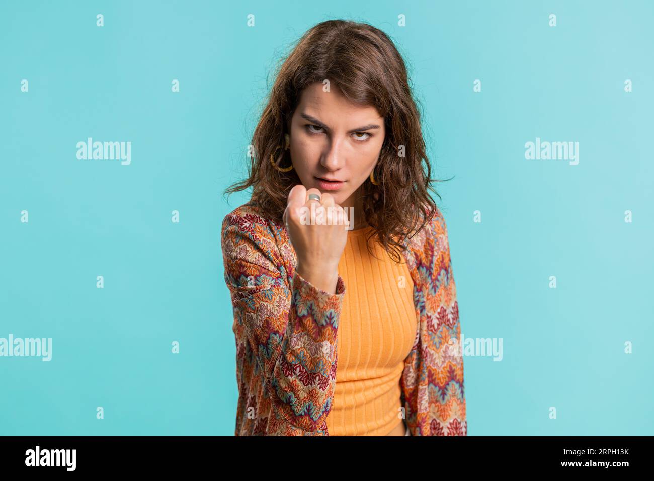 Aggressive angry young Caucasian woman trying to fight at camera ...