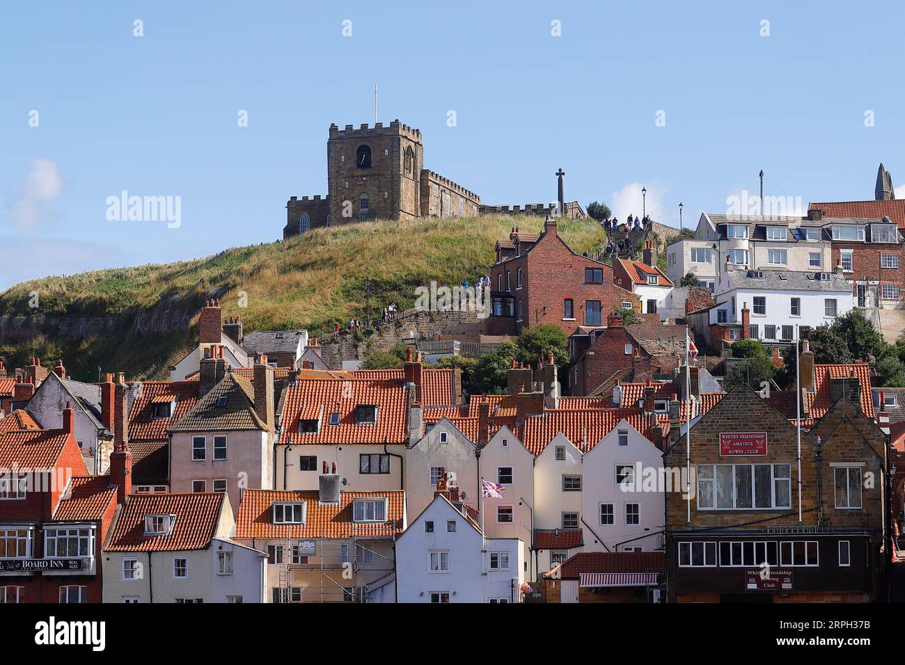 A view of Whitby from the harbour with St Marys Church sat on the cliff ...