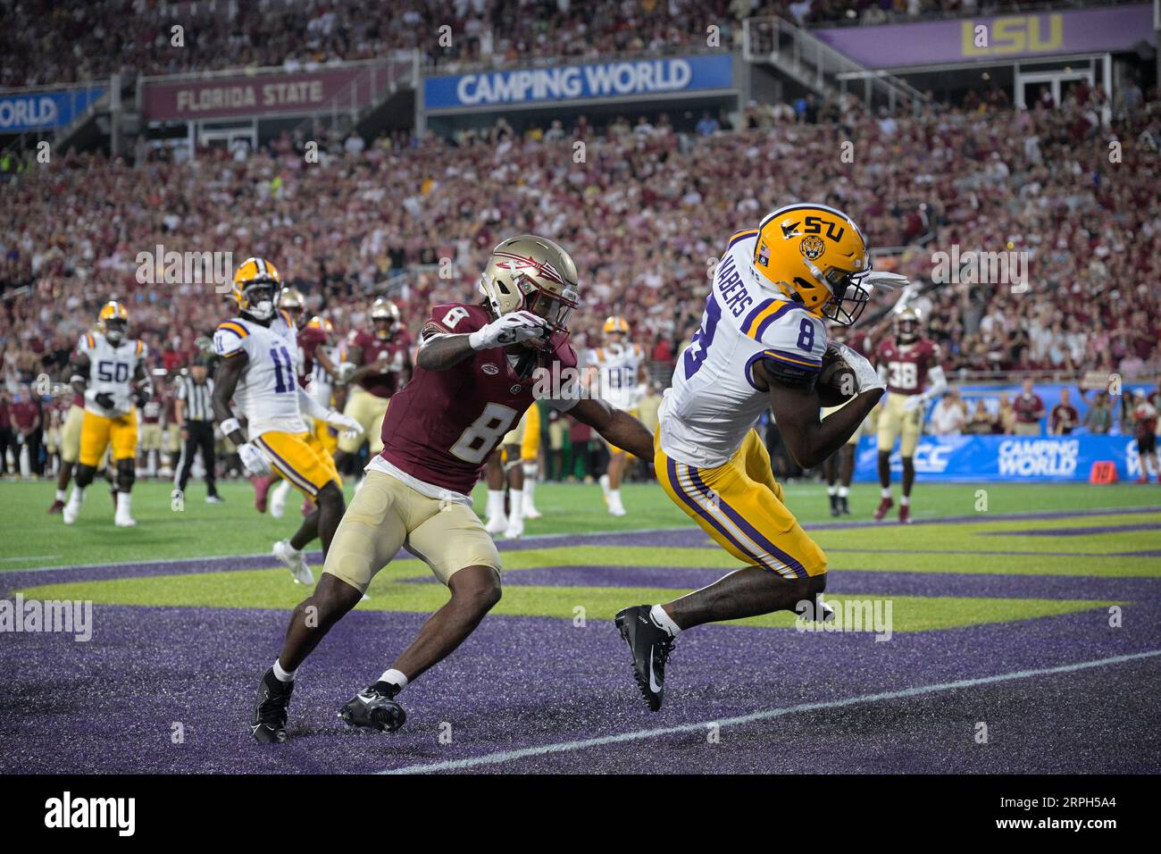 LSU wide receiver Malik Nabers (8), right, catches a pass out of bounds ...